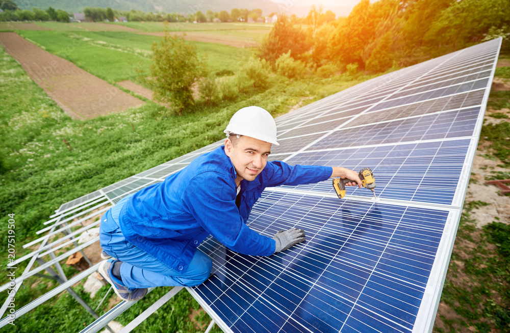 Construction worker connects photo voltaic panel to solar system using ...