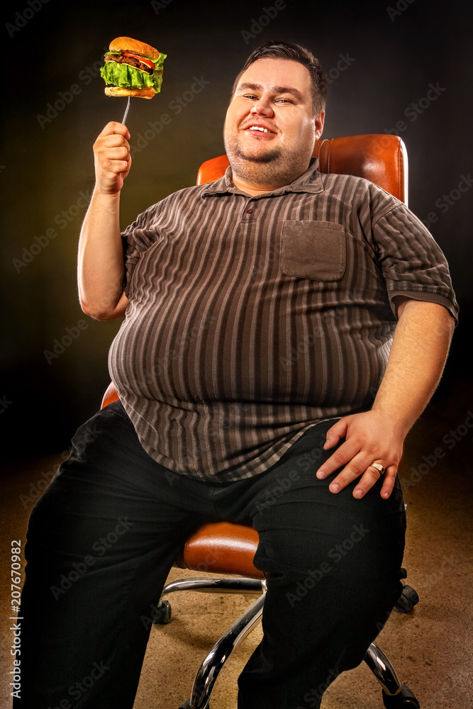 Diet failure of fat man eating fast food hamberger. Happy overweight ...