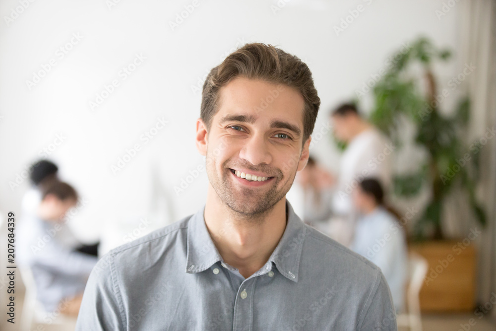 Portrait of casual smiling Caucasian male worker laughing looking at ...