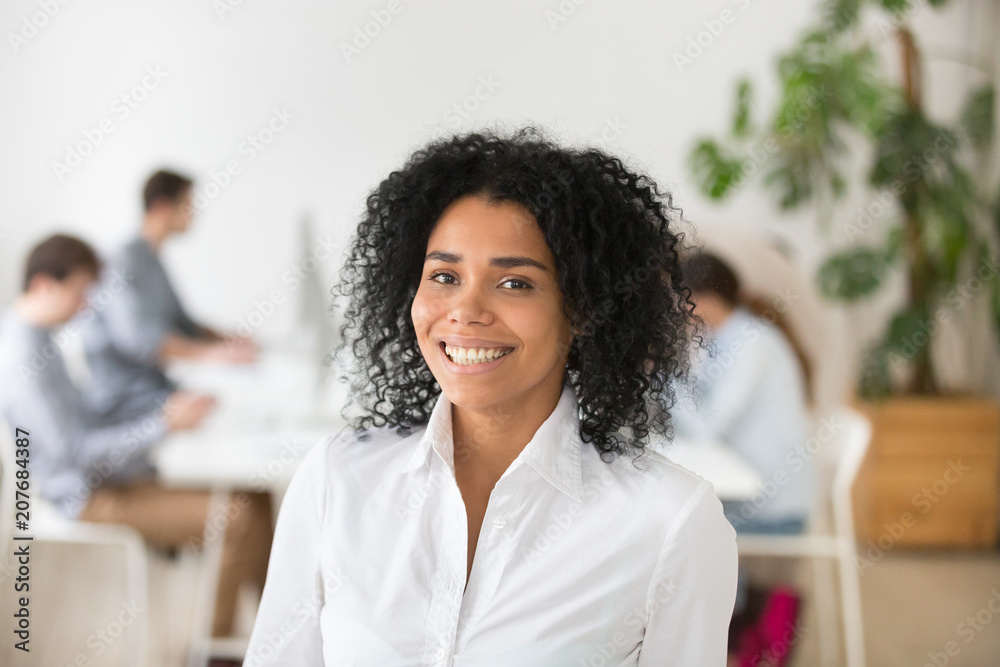 Portrait of smiling African American worker laughing looking at camera ...
