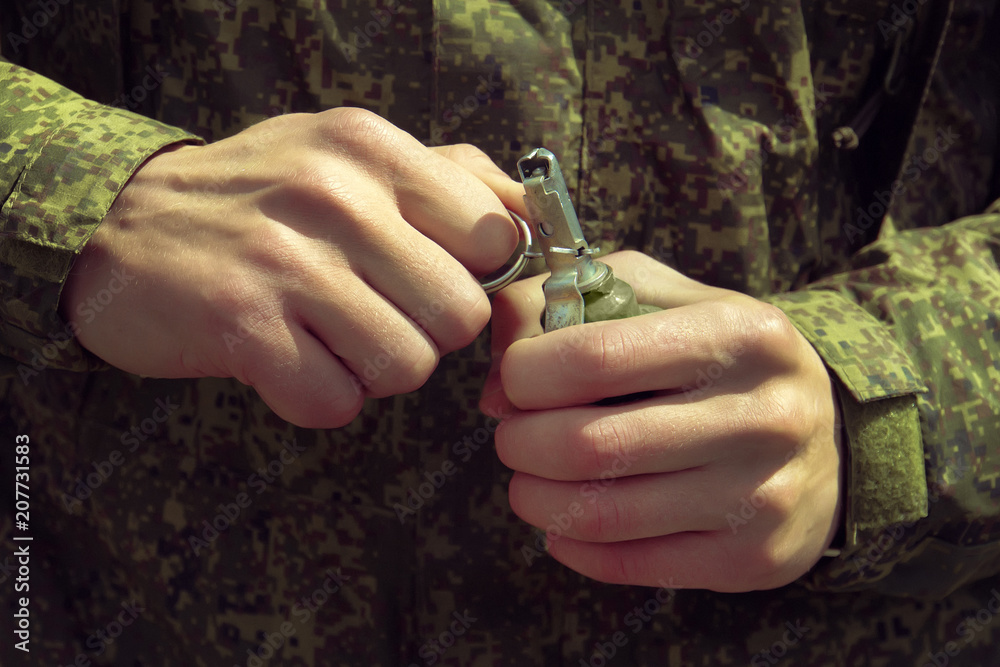 Grenade, Hands on Pin. the soldier pulls a check from a fragmentation ...
