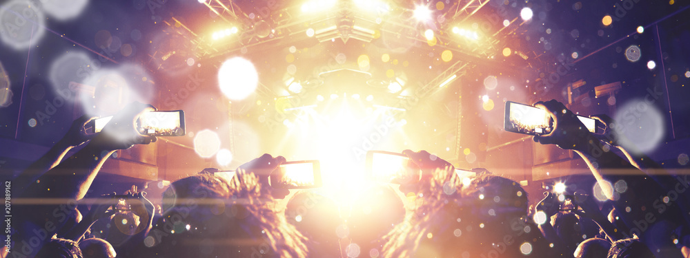Concert stage with cheerful fans, lens flare and distress effects are ...