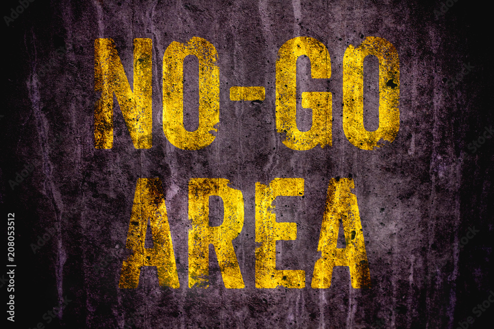 “No-Go Area” warning sign in yellow letters painted over dark grungy ...