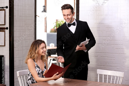 Young waiter taking order from client in restaurant - Koop deze ...