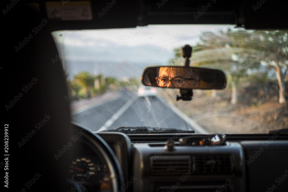 adult senior woman drive the car. inside point of view with focus on ...