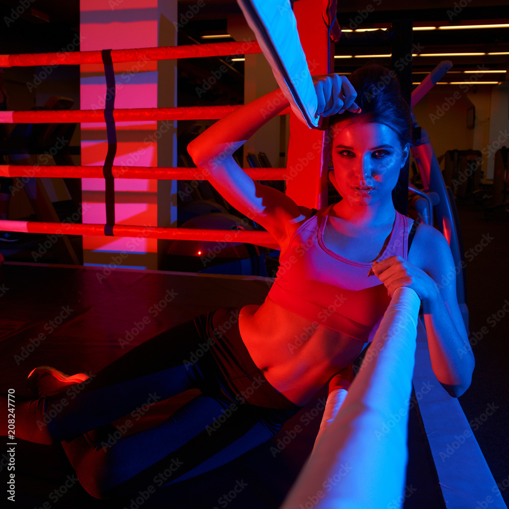 Seductive female fitness model with pony tail hairstyle, dressed in ...