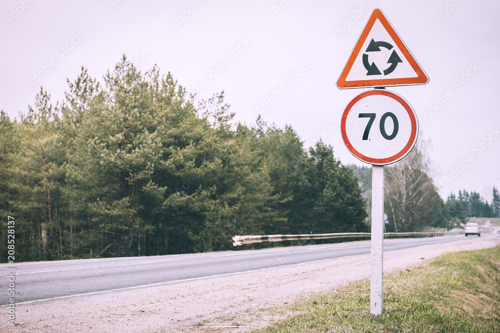 Road sign speed limit to 70 and warning sign that soon there will be a ...
