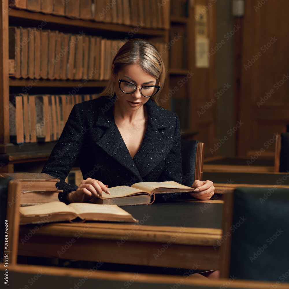 Beautiful blonde woman wearing elegant black tweed jacket and glasses ...