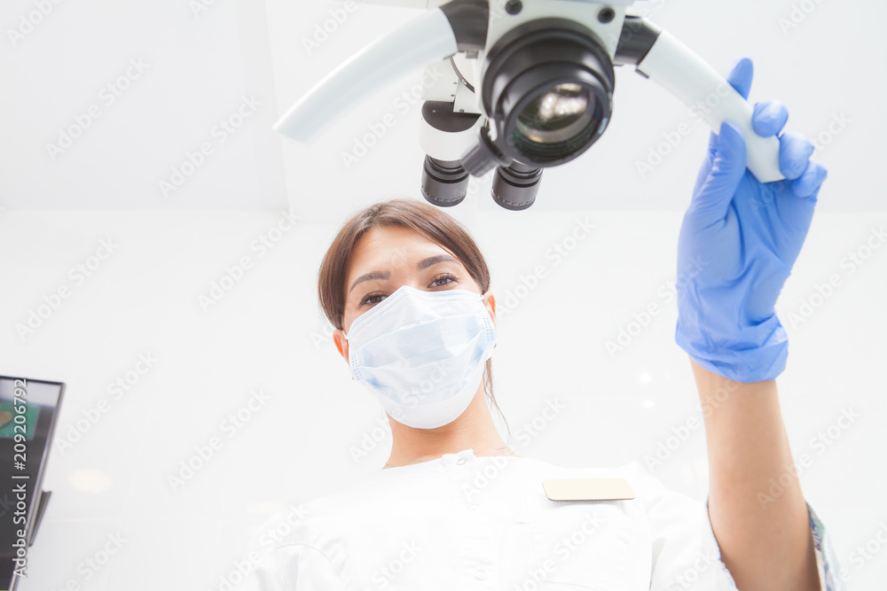 Professional dental endodontic binocular microscope in a treatment room ...
