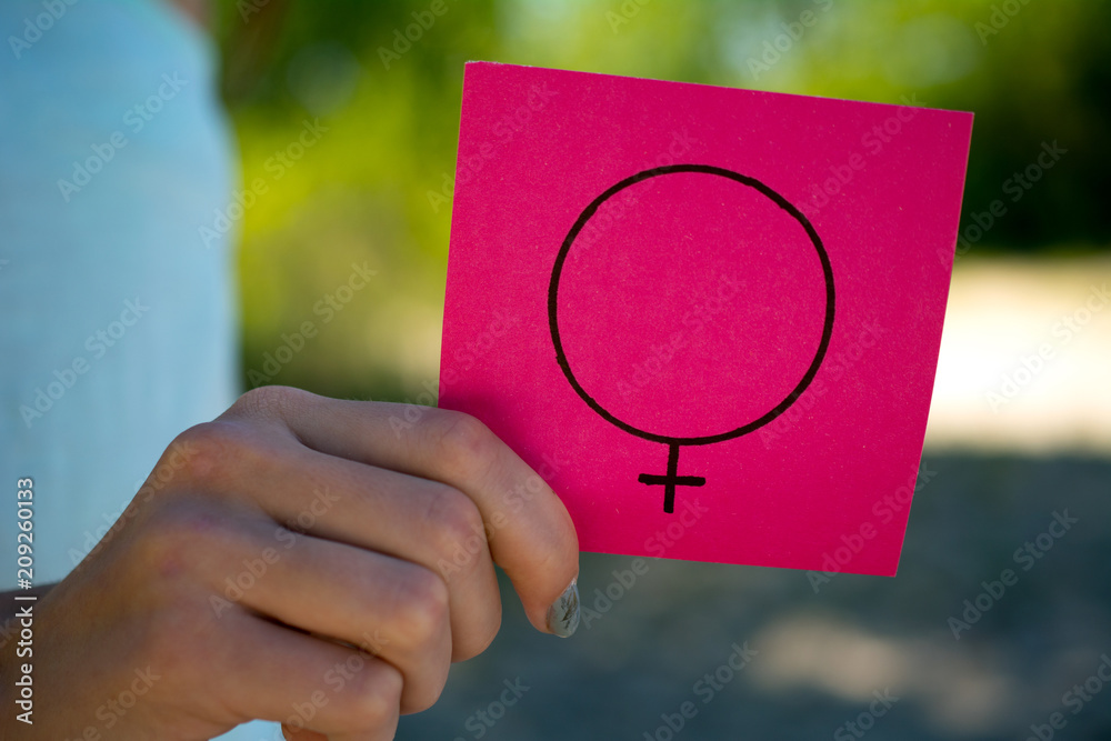 gender equality concept, a piece of paper with a female symbol in a ...