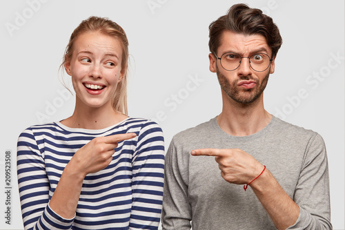 Horizontal shot of two female and male best friends express different ...