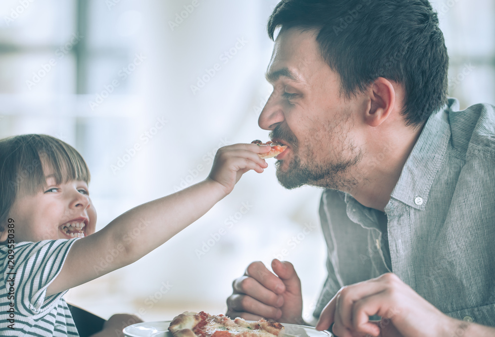 Dad and daughter eat pizza Stock Photo | Adobe Stock