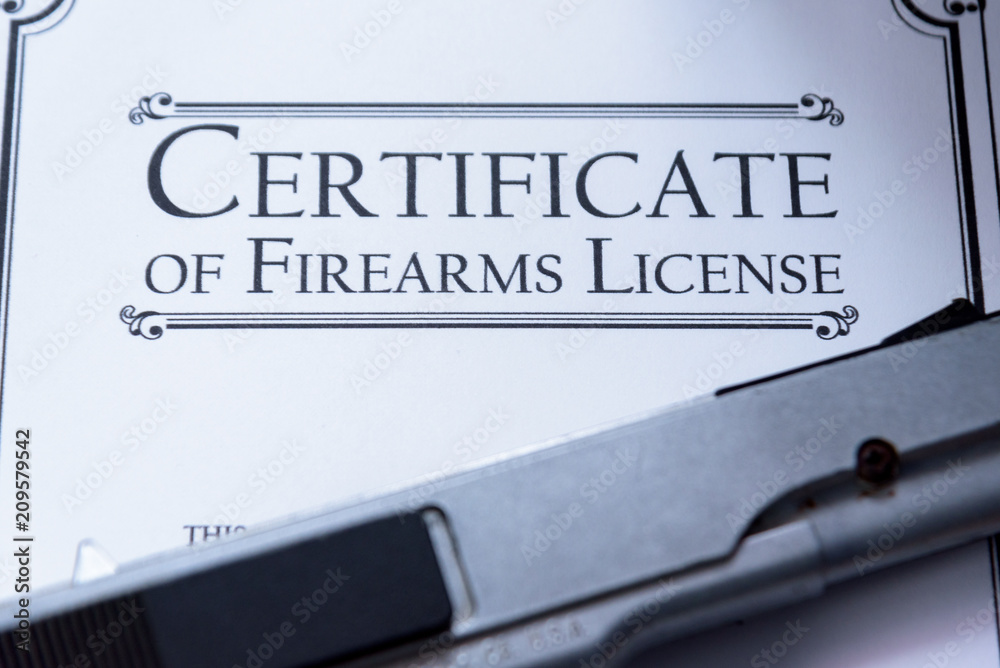 Hangun laying on a Gun / Firearms License Certificate Stock Photo ...