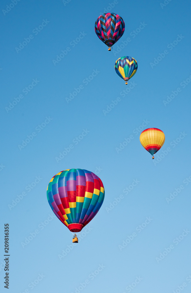 Four Hot Air Balloons Flying High in a Clear, Blue Sky at the Hot Air ...