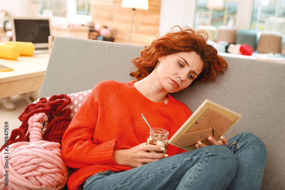 Missing boyfriend. Red-haired young woman feeling very sentimental ...