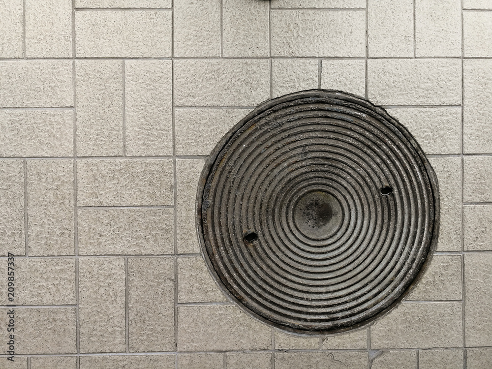 Steel circle drain cap on pedestrian walkway, drain hose made from ...