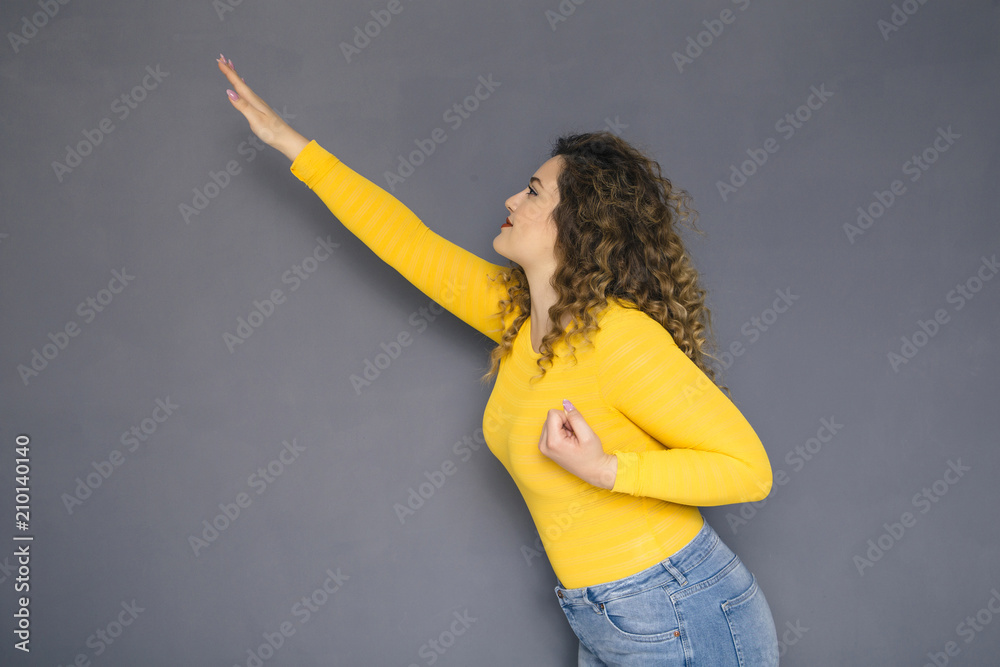 Cute brunette plus size woman with curly hair in yellow sweater and ...