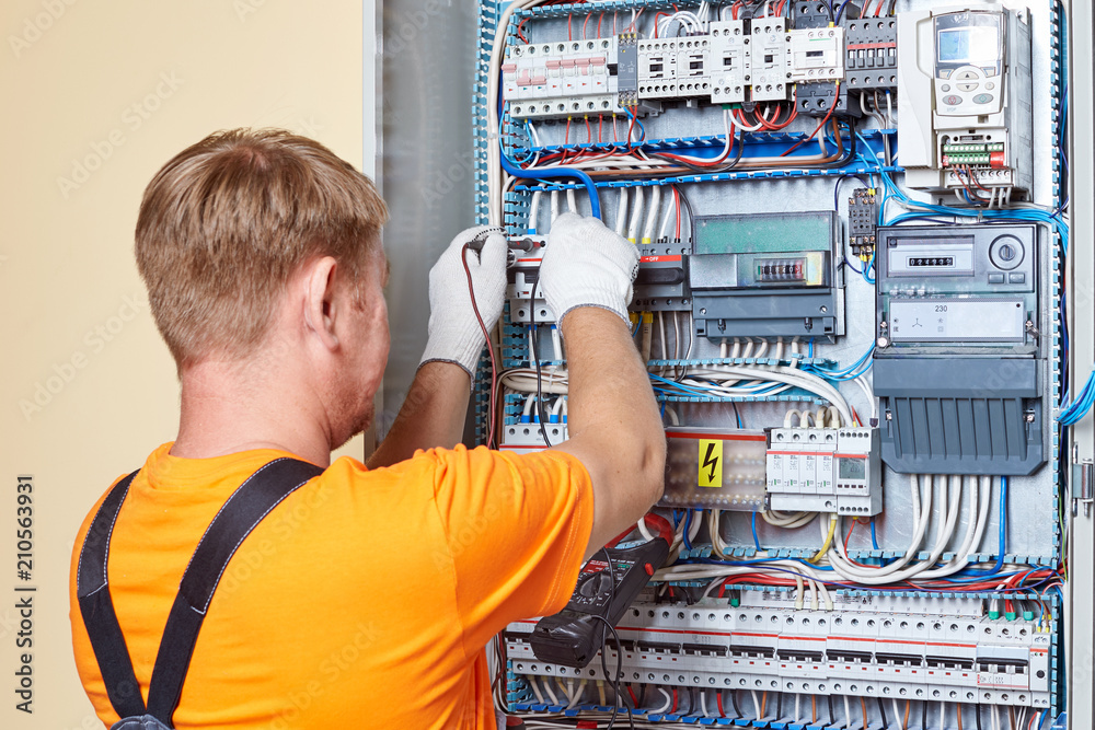 Engineer tests power high voltage three phase circuit box with ...