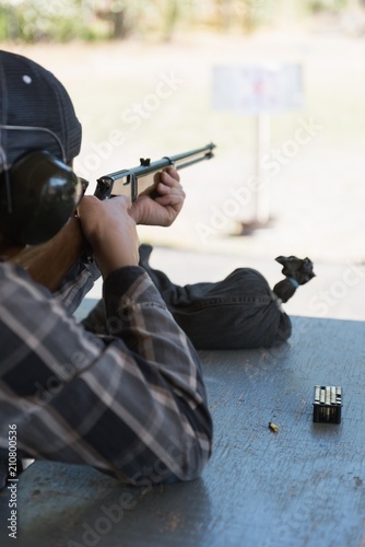 Man aiming shotgun at target in shooting range - Buy this stock photo ...