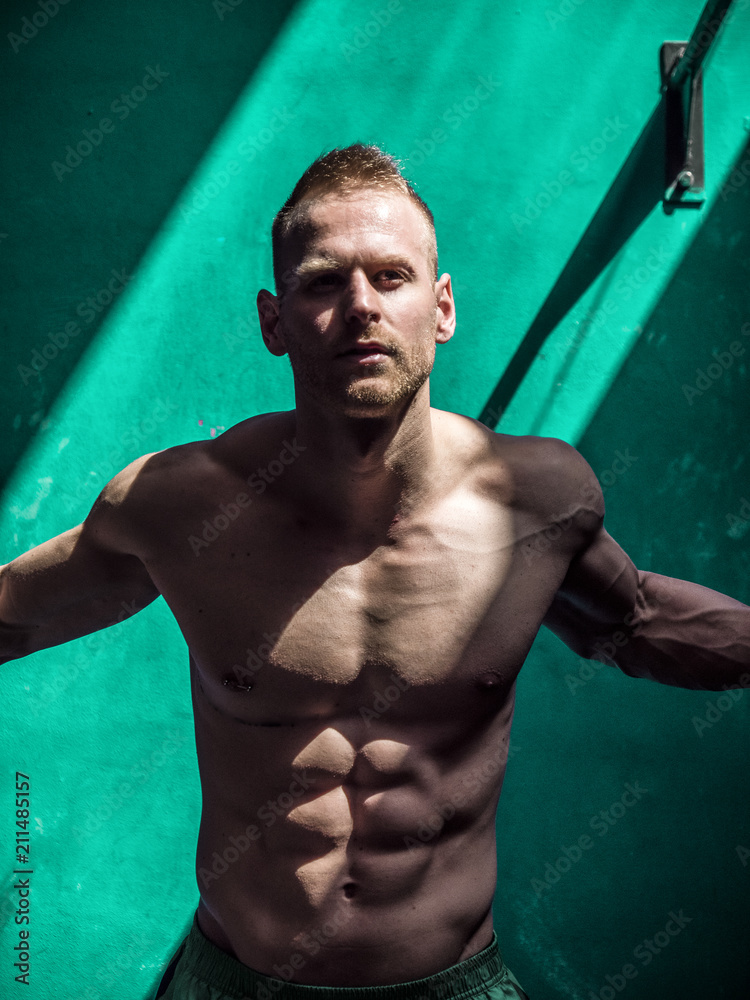 Стокове фото Attractive shirtless blond male bodybuilder in shorts ...