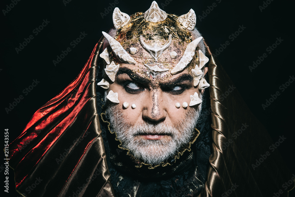 Evil demon with spikes on face and glittering skin wearing metallic ...