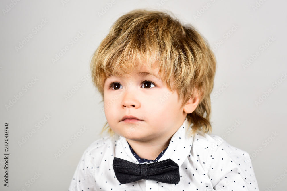 Cute little boy in fashionable shirt and bow tie. Sad little boy ...