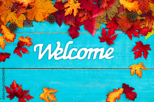 Welcome sign with colorful autumn leaves border hanging on rustic ...