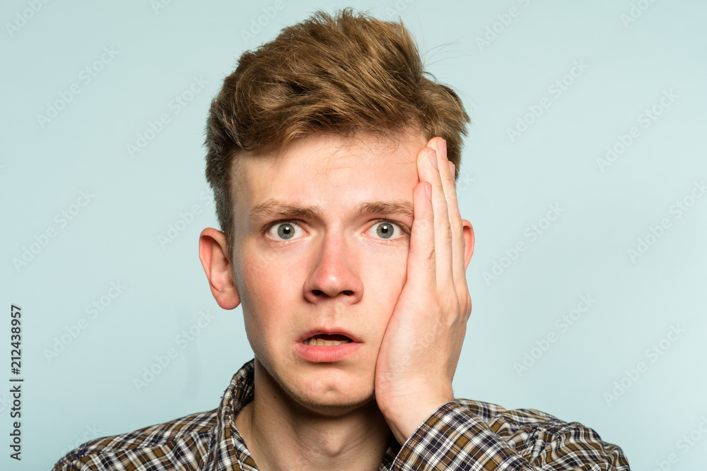 scared shocked terrified frightened startled man clutching hands to his ...