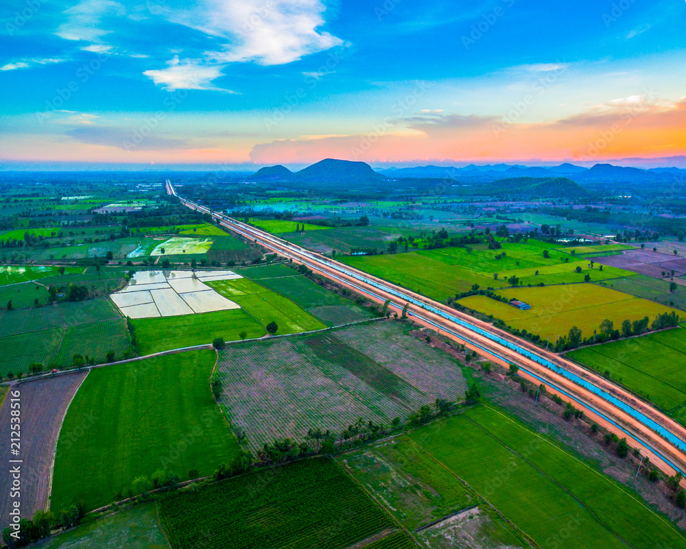 aerial view scenery sunset on new route pass in the rice field. under ...