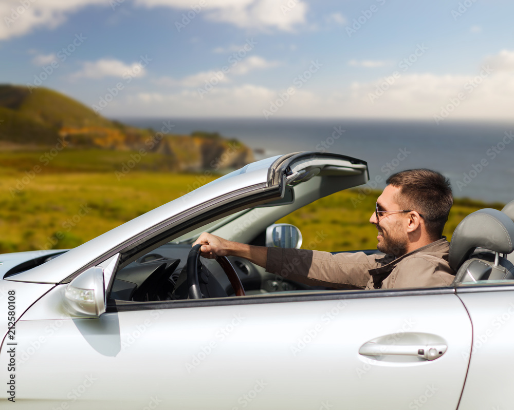 road trip, travel and people concept - happy man driving convertible ...