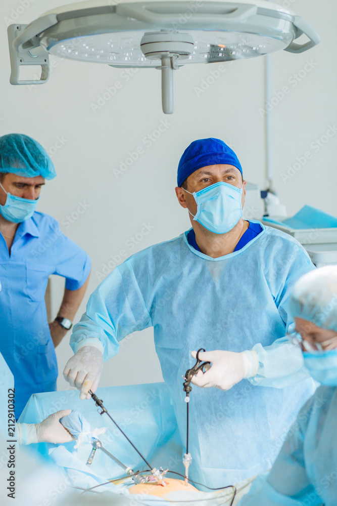 Surgeons team preforming operation uterus removal in hospital operating ...