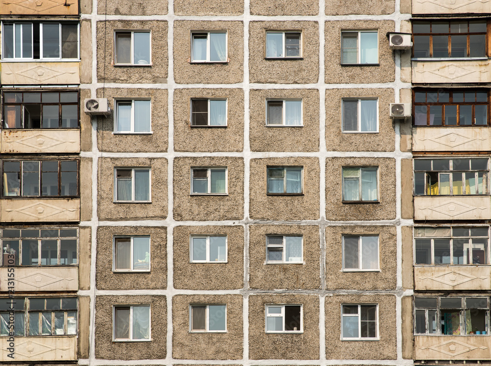The texture of the wall of the apartment building with old windows and ...
