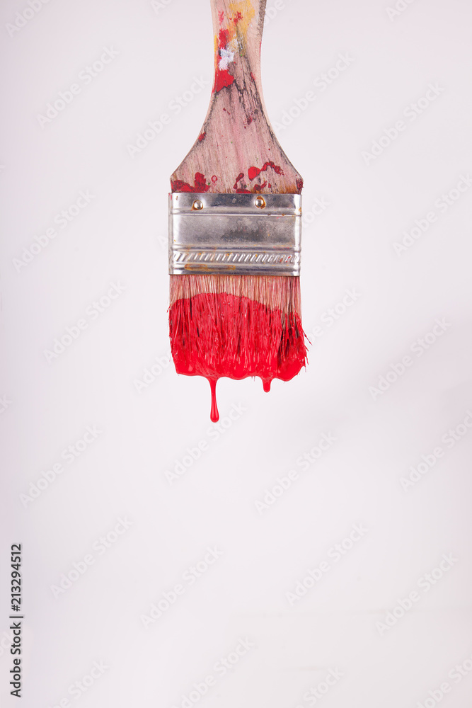 Vertical paint brush with red wet paint dripping from paintbrush on ...