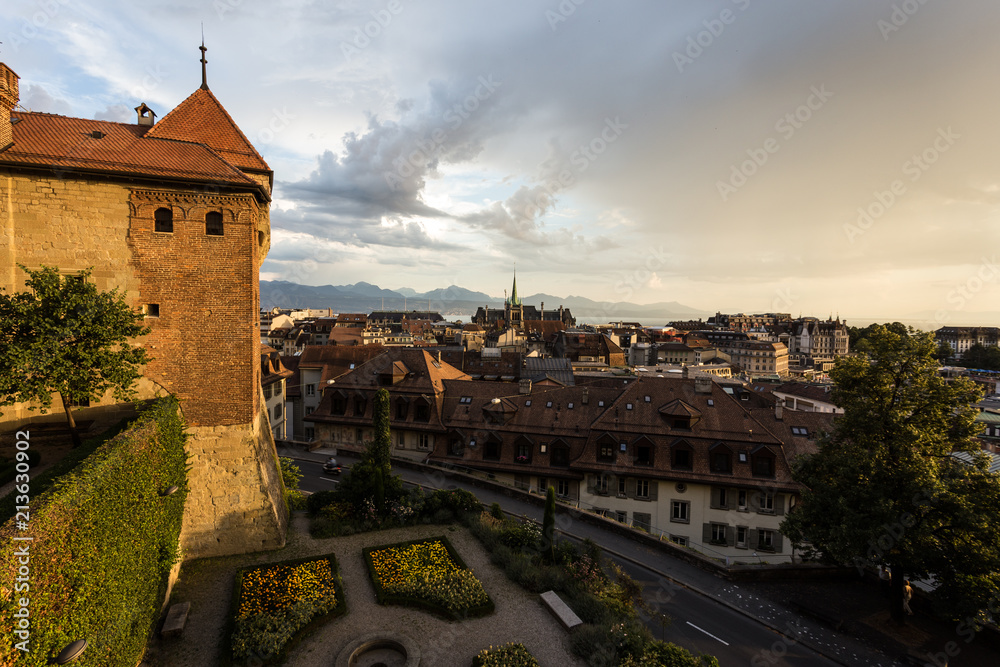 Sunset over Lausanne with its medieval castle and lake Geneva and the ...