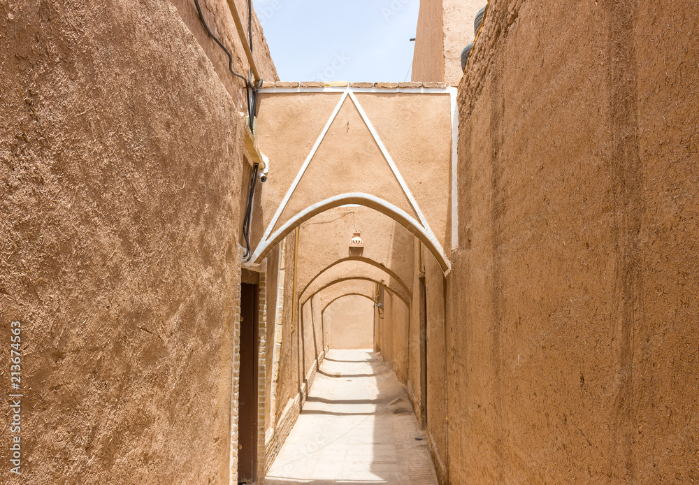 Old narrow beautiful streets of old town in Yazd, Iran. Poor houses ...