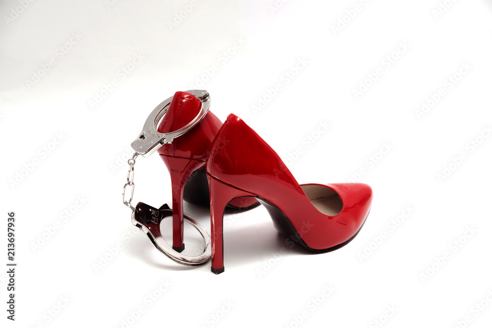 Handcuffs and sexy red high heels on white background. Fetish erotic ...
