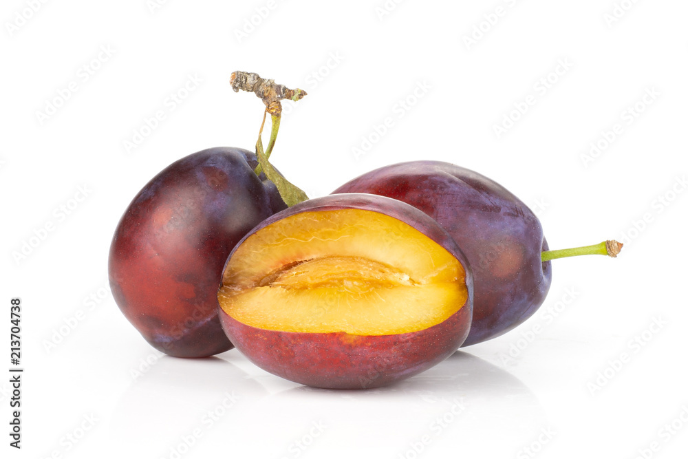 Group of two whole one half of fresh violet-blue plum vibrant moyer ...