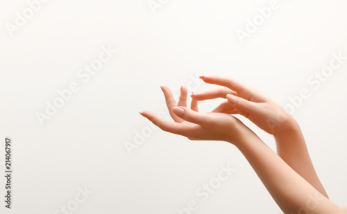 Closeup image of beautiful woman's hands with light pink manicure on the nails. Skin care for ...