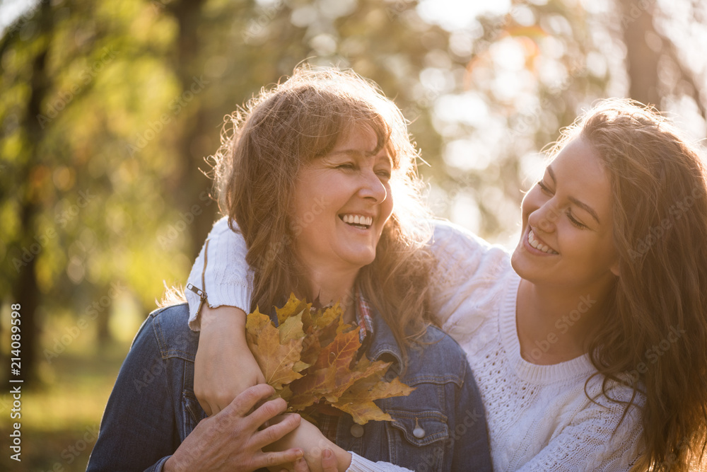 Daughter hugging her mother from behind Stock Photo | Adobe Stock