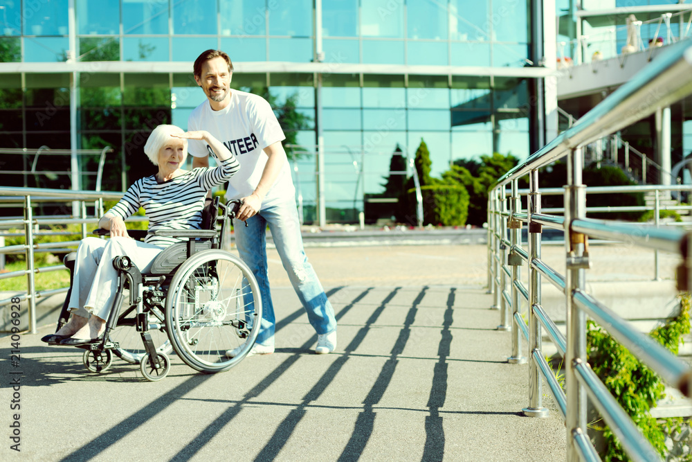 Cannot see. Joyful female person raising her left hand and looking ...