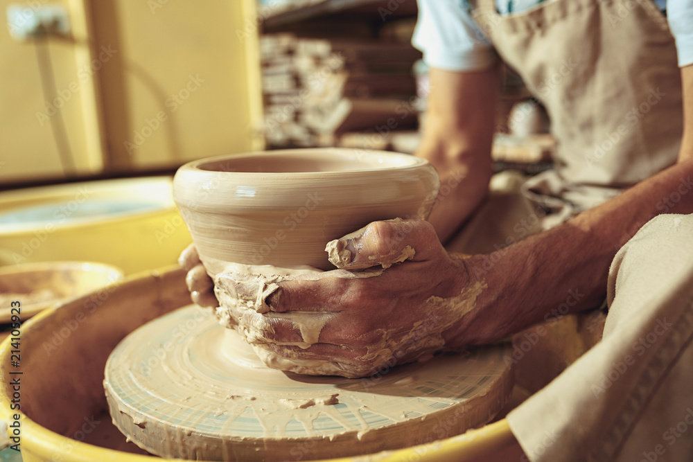 Creating a jar or vase of white clay close-up. Master crock. Man hands ...