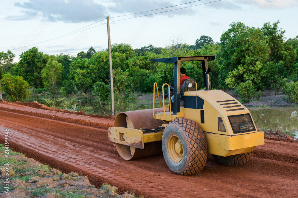 Roller steamroller or vibratory roller machine working on road ...