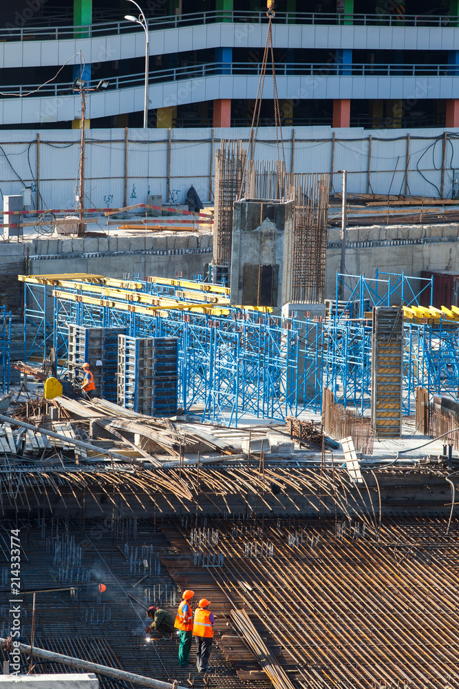 Construction of a large multi-storey commercial building. Builders work ...