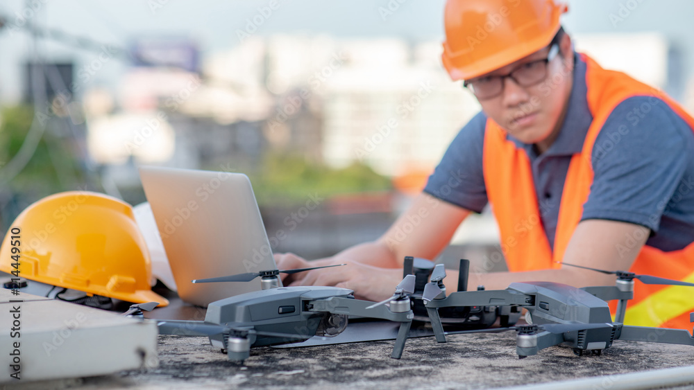 Young Asian engineer man working with drone laptop and smartphone at ...
