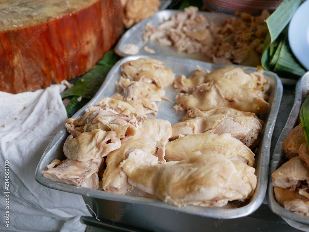 Prepared boiled chicken ready to be chopped and served on top of garlic ...