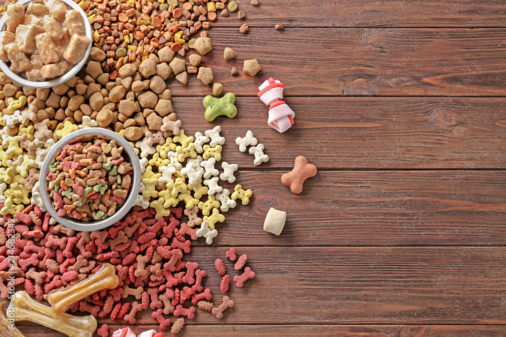 Different pet food on wooden background Stock Photo | Adobe Stock