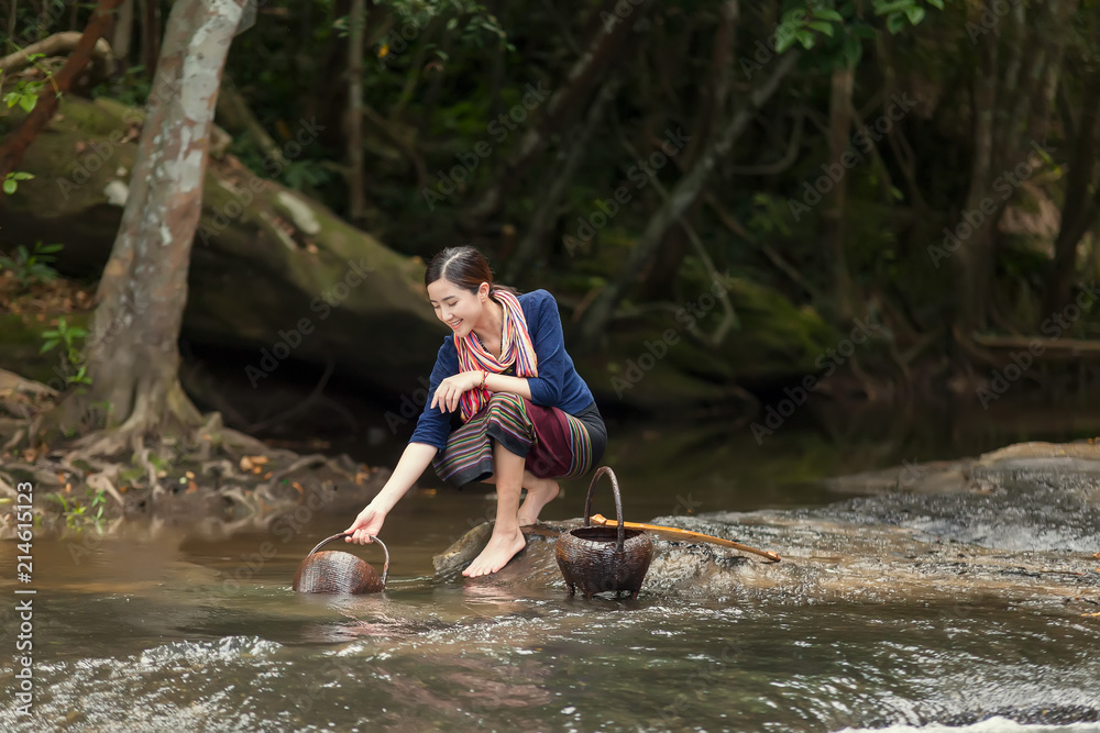 Beautiful women take some water in the river to use in daily life at ...