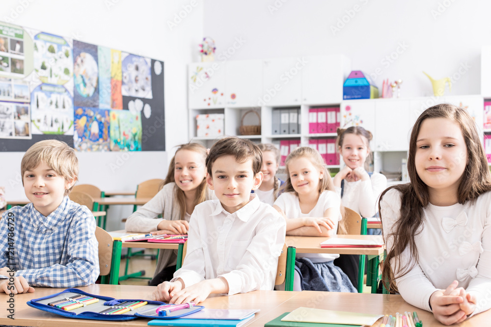 Classroom with polite and smiling kids during lesson in the school ...
