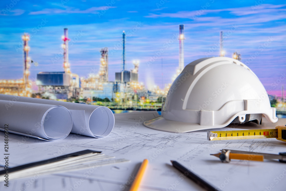 Architectural drawing plan of refinery plant with blueprint rolls ...