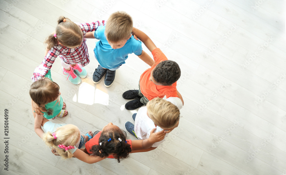Little children making circle with hands around each other indoors, top ...